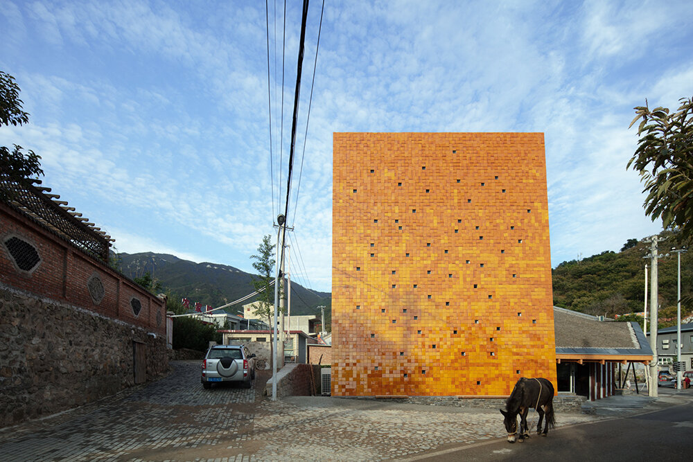 WAAAM museum's glazed yellowish tiles enliven beigou village in china