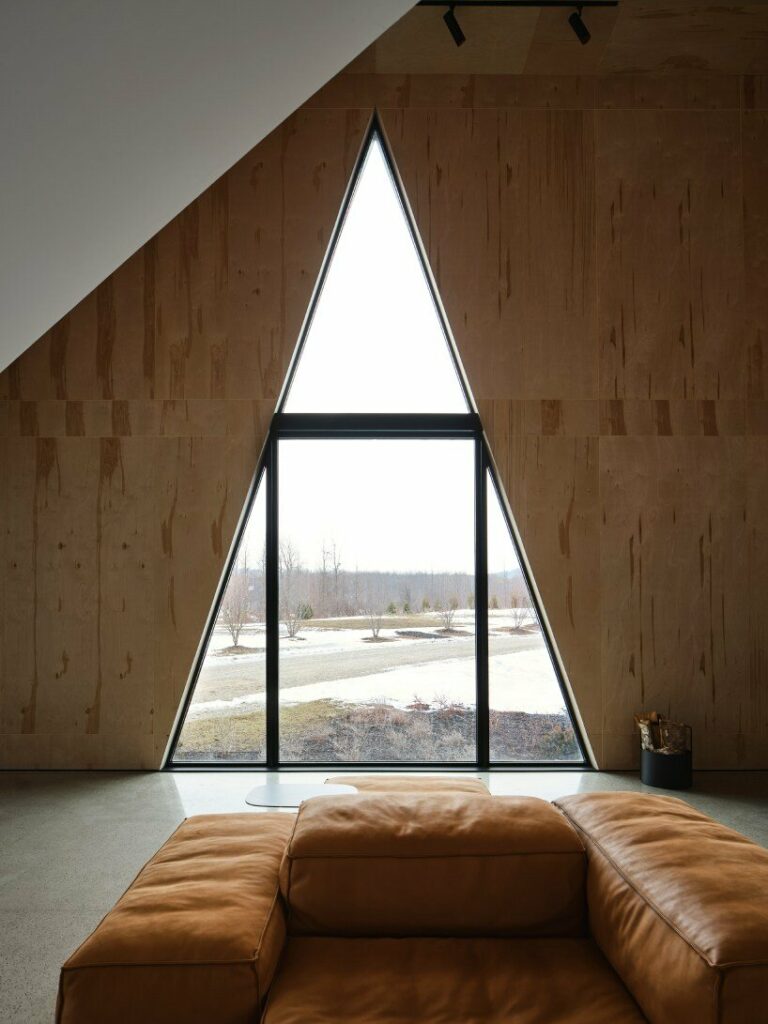 atelier RZLBD's charred wood ski chalet tucks into slope in canada