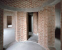 christian kerez's house okamura unfolds as circular brick columns in ...