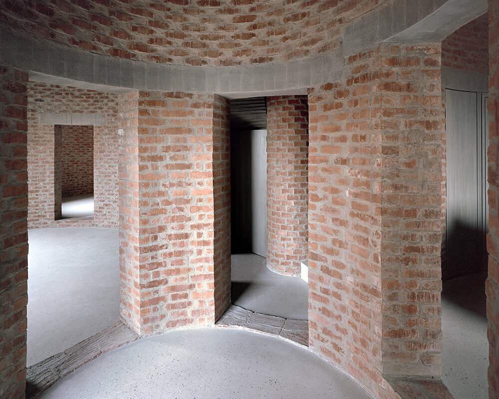christian kerez's house okamura unfolds as circular brick columns in ...