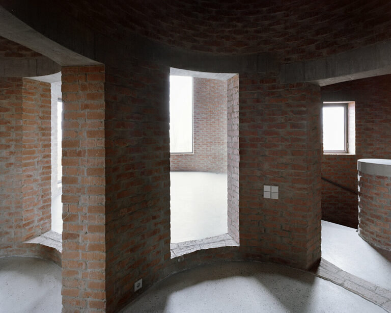 christian kerez's house okamura unfolds as circular brick columns in ...