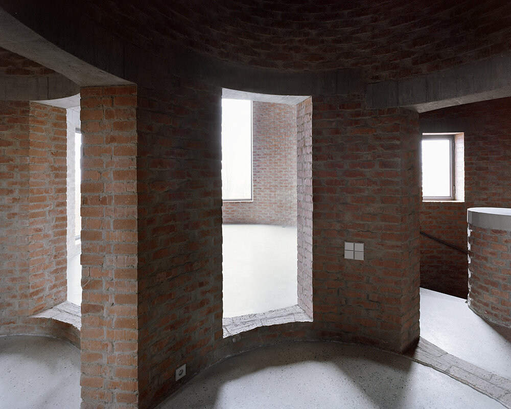 christian kerez's house okamura unfolds as circular brick columns in ...