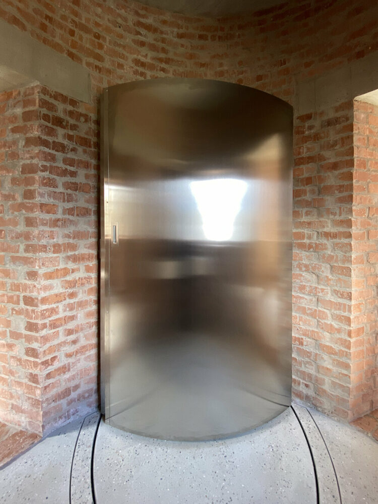 christian kerez's house okamura unfolds as circular brick columns in ...