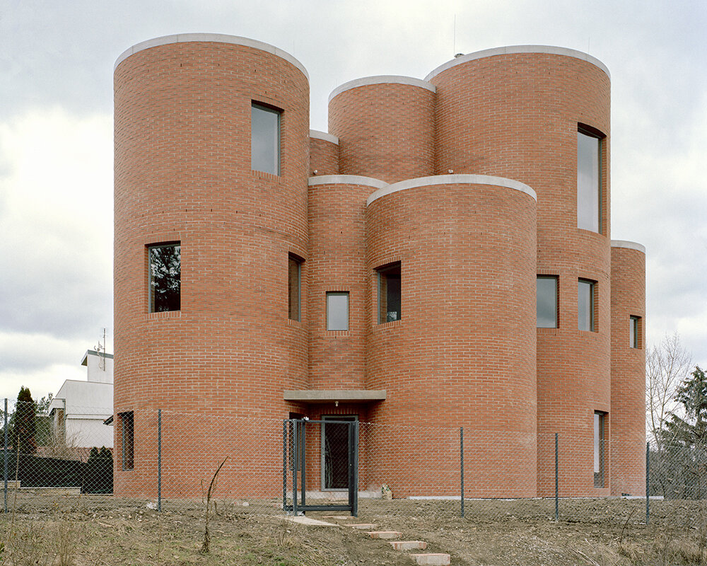 christian kerez's house okamura unfolds as circular brick columns in ...
