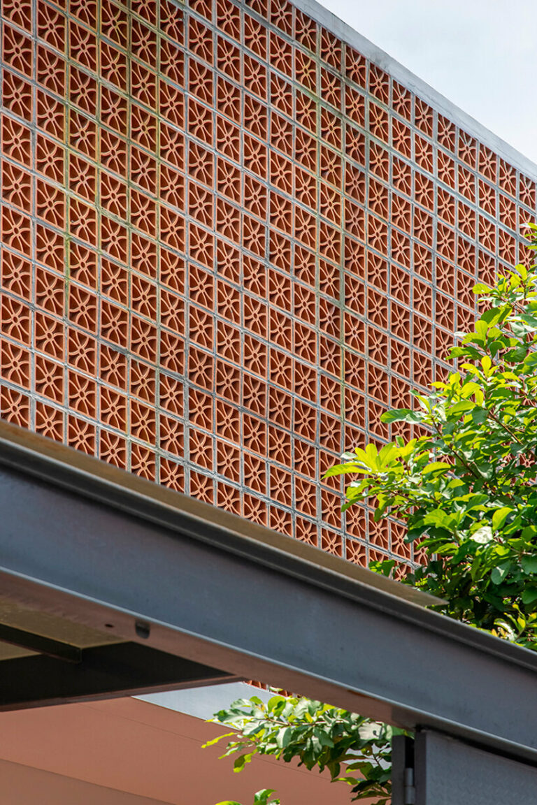 perforated double-skin brick facade shields grand house in vietnam