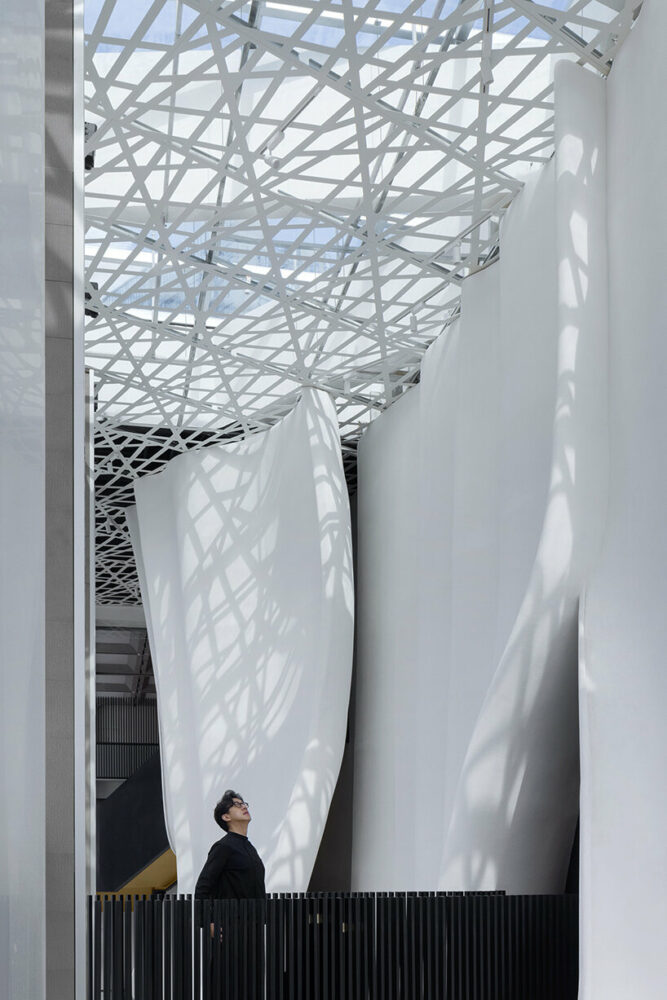 the veil: groundwork sculpts sinuous architecture like draped fabric