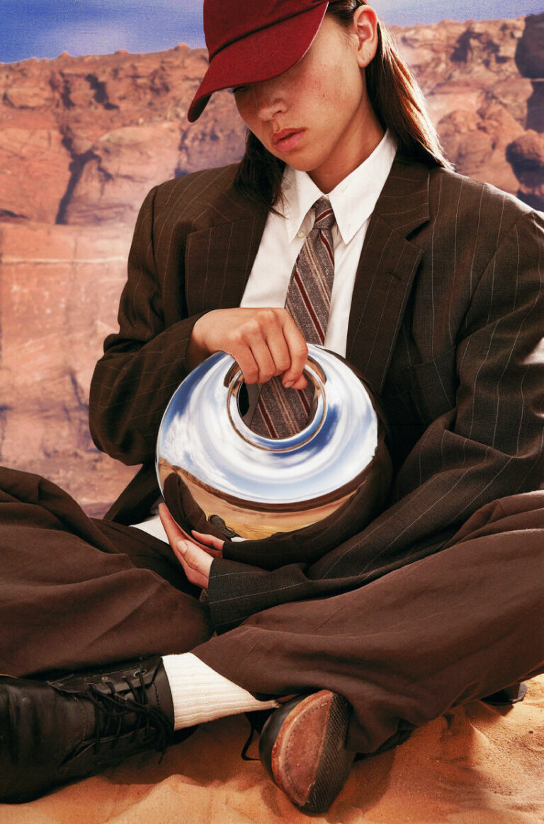 nik bentel's mathematics-inspired 'orb bag' gets a shiny finish for a warping mirror effect