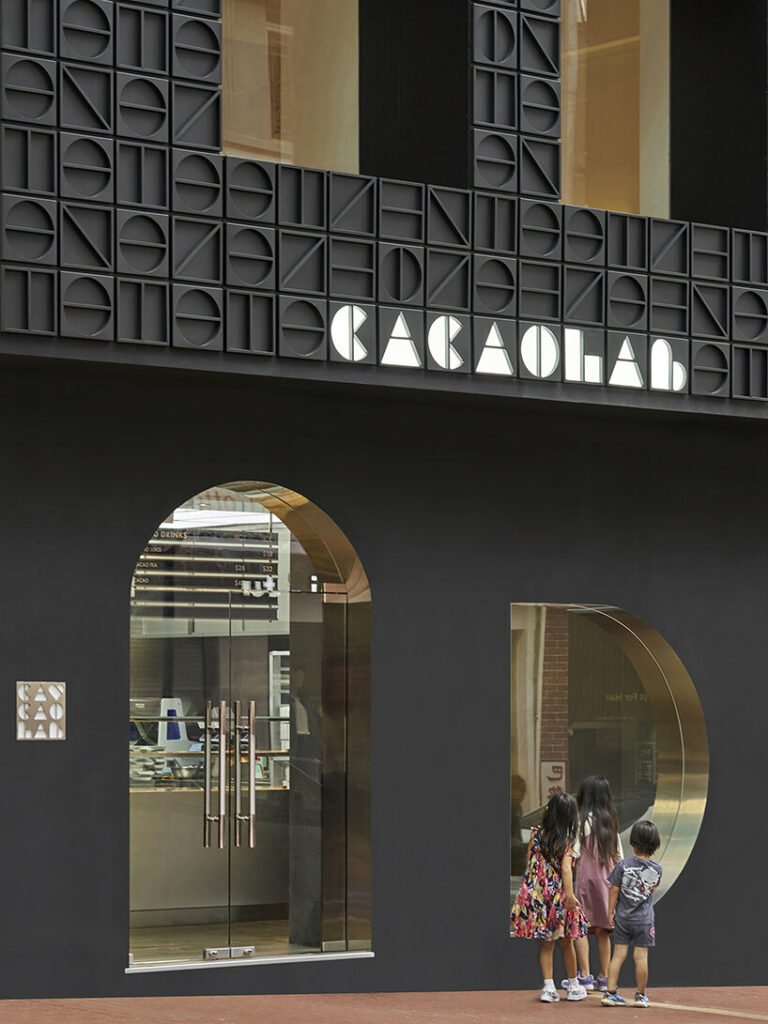 other projects' monogram facade conceals new-age cacaolab flagship store in hong kong