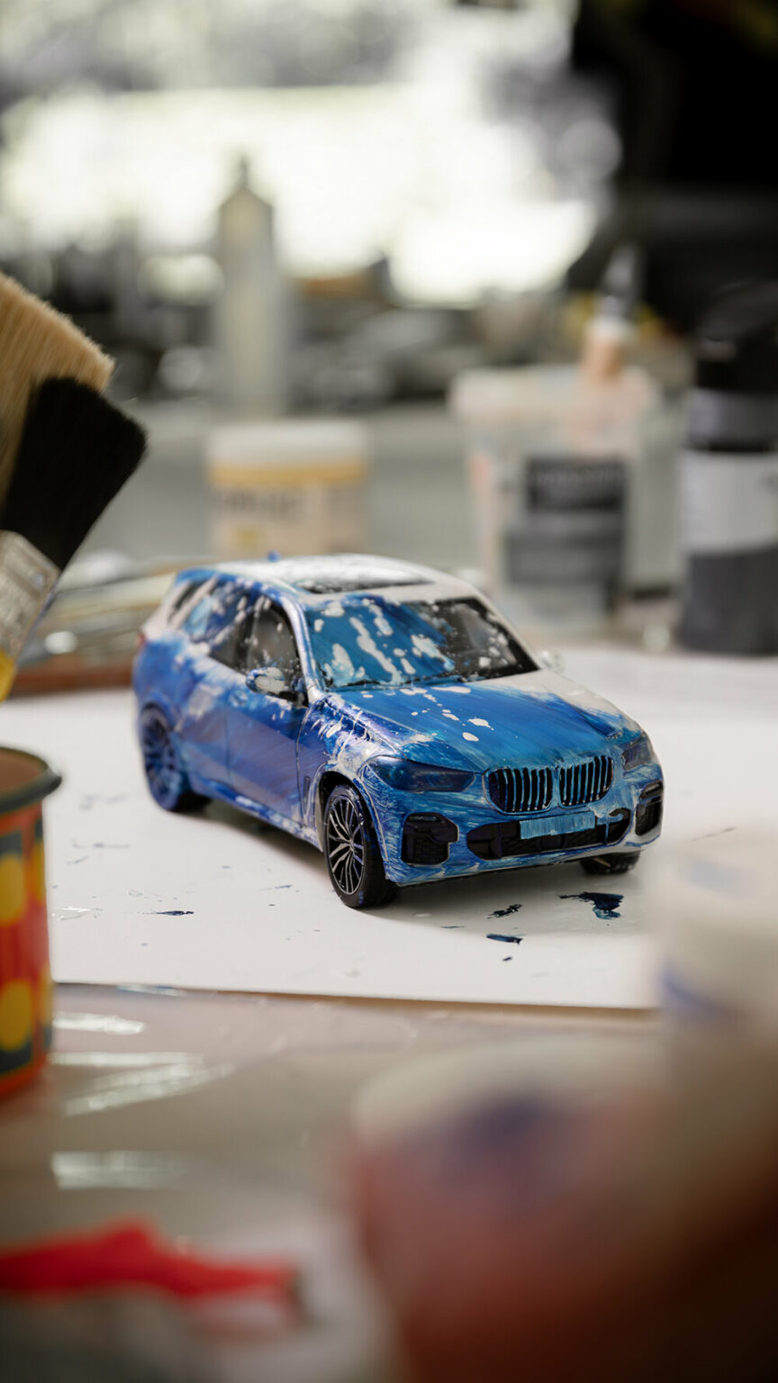es devlin wraps BMW iX5 hydrogen in blue & white collage at art basel