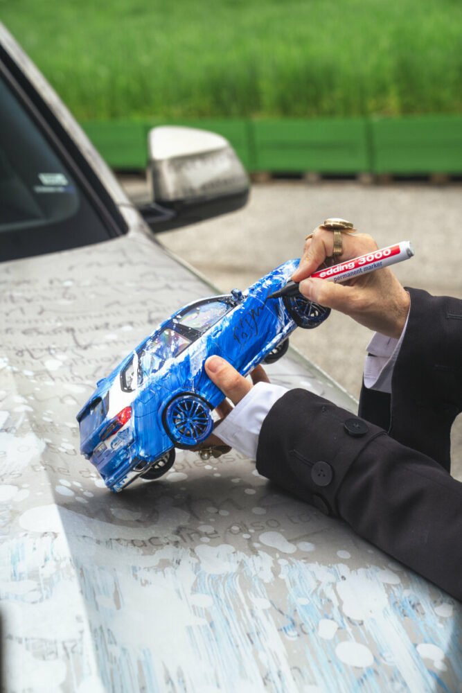 es devlin wraps BMW iX5 hydrogen in blue & white collage at art basel