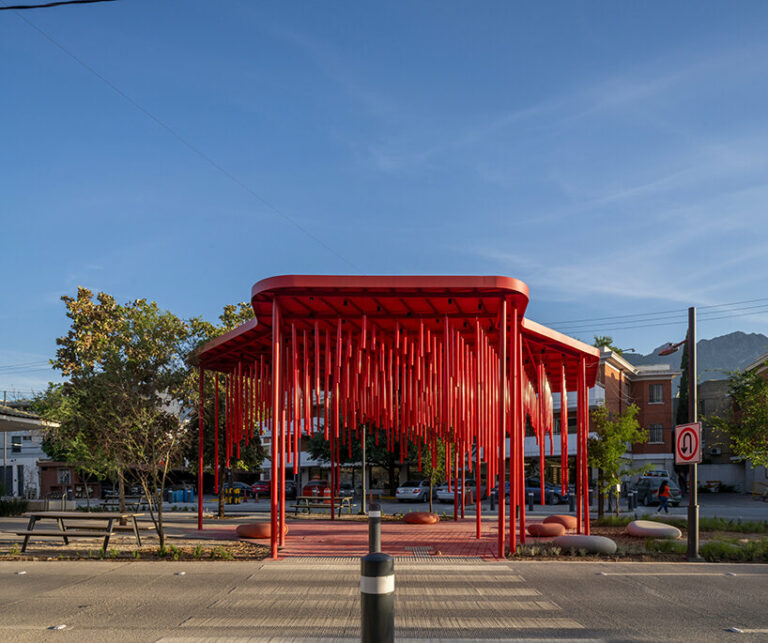 melodic pvc tubes attract pedestrians inside red-painted pavilion in mexico