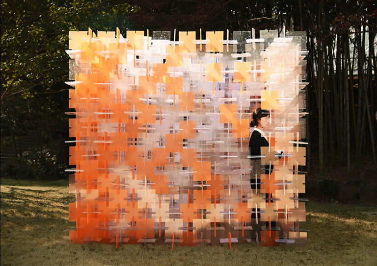 over 3,500 recyclable polycarbonate panels assemble paired cubes ...