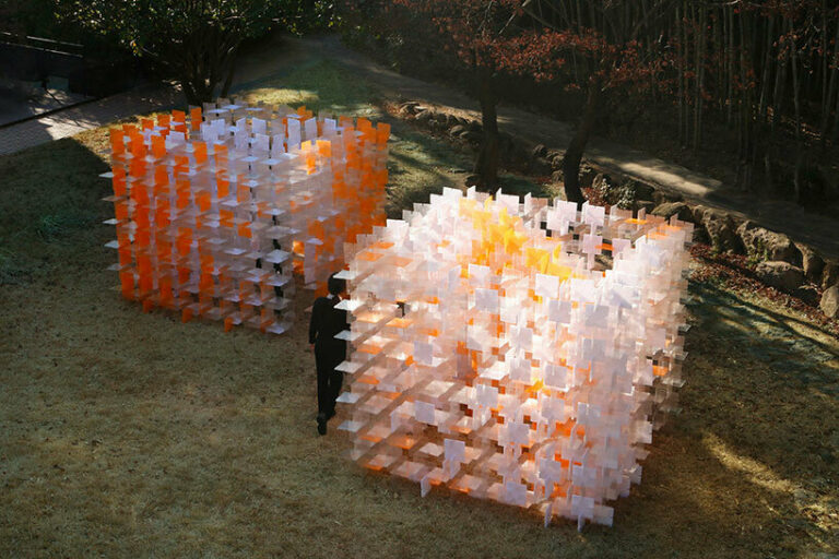 over 3,500 recyclable polycarbonate panels assemble paired cubes ...