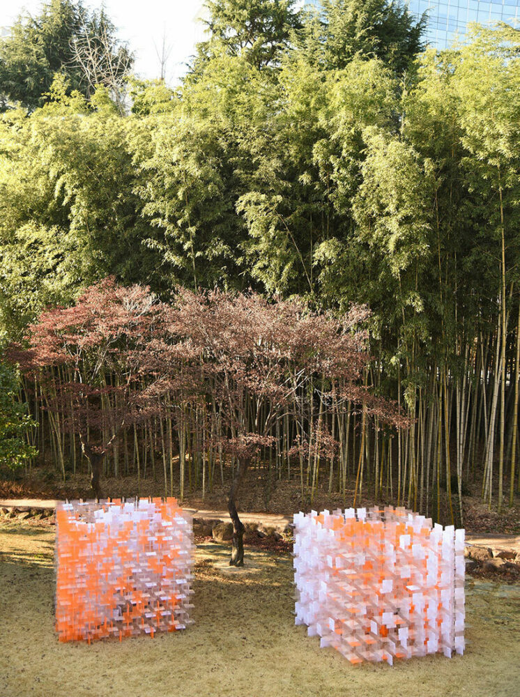 over 3,500 recyclable polycarbonate panels assemble paired cubes ...
