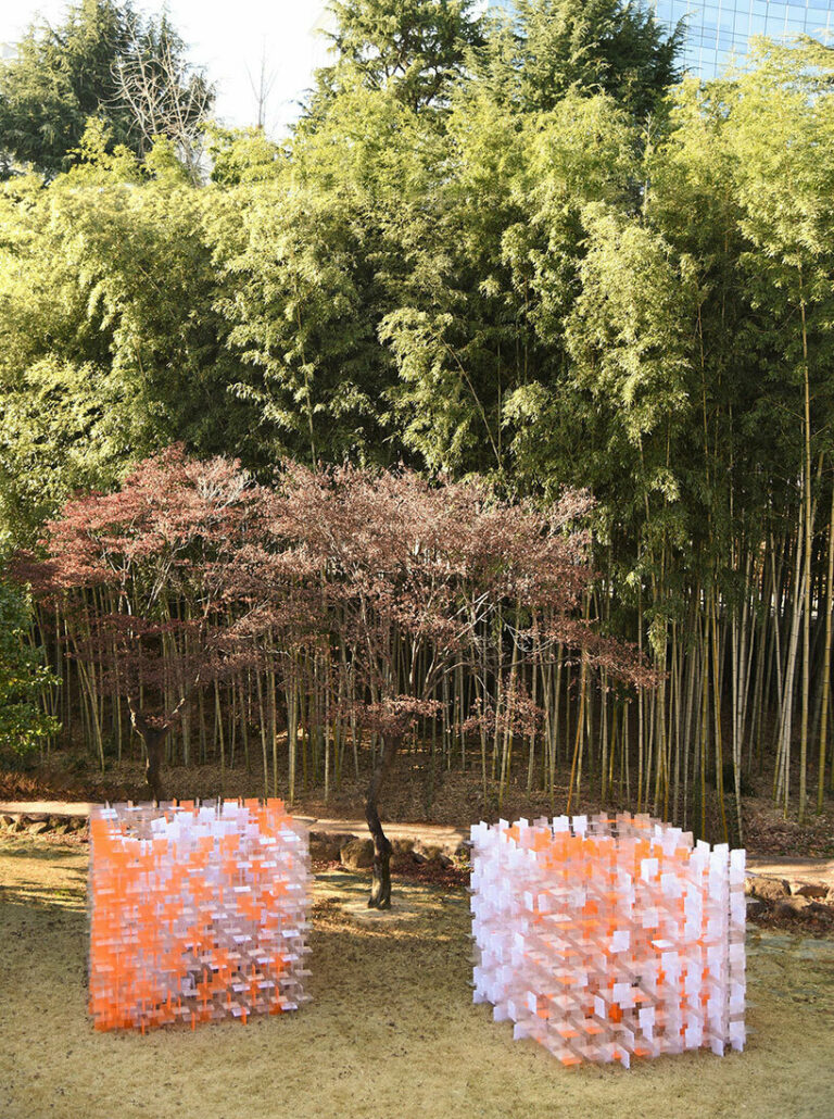 over 3,500 recyclable polycarbonate panels assemble paired cubes ...