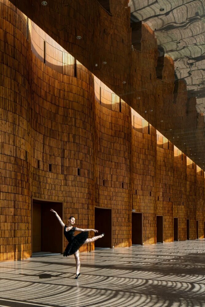 undulating wooden panels form veil-like facade in vietnamese conference ...
