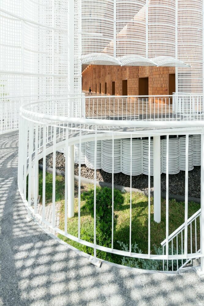 undulating wooden panels form veil-like facade in vietnamese conference ...