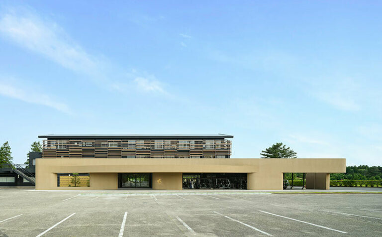 kubo tsushima architects sculpts earthy curved facade for renovated golf club in japan