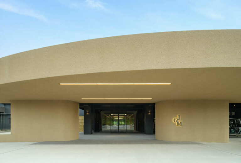 kubo tsushima architects sculpts earthy curved facade for renovated golf club in japan