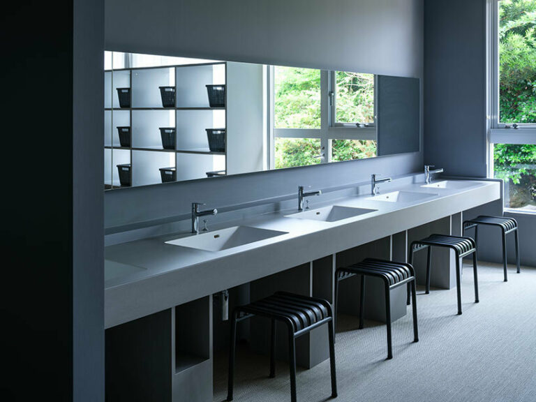 kubo tsushima architects sculpts earthy curved facade for renovated golf club in japan