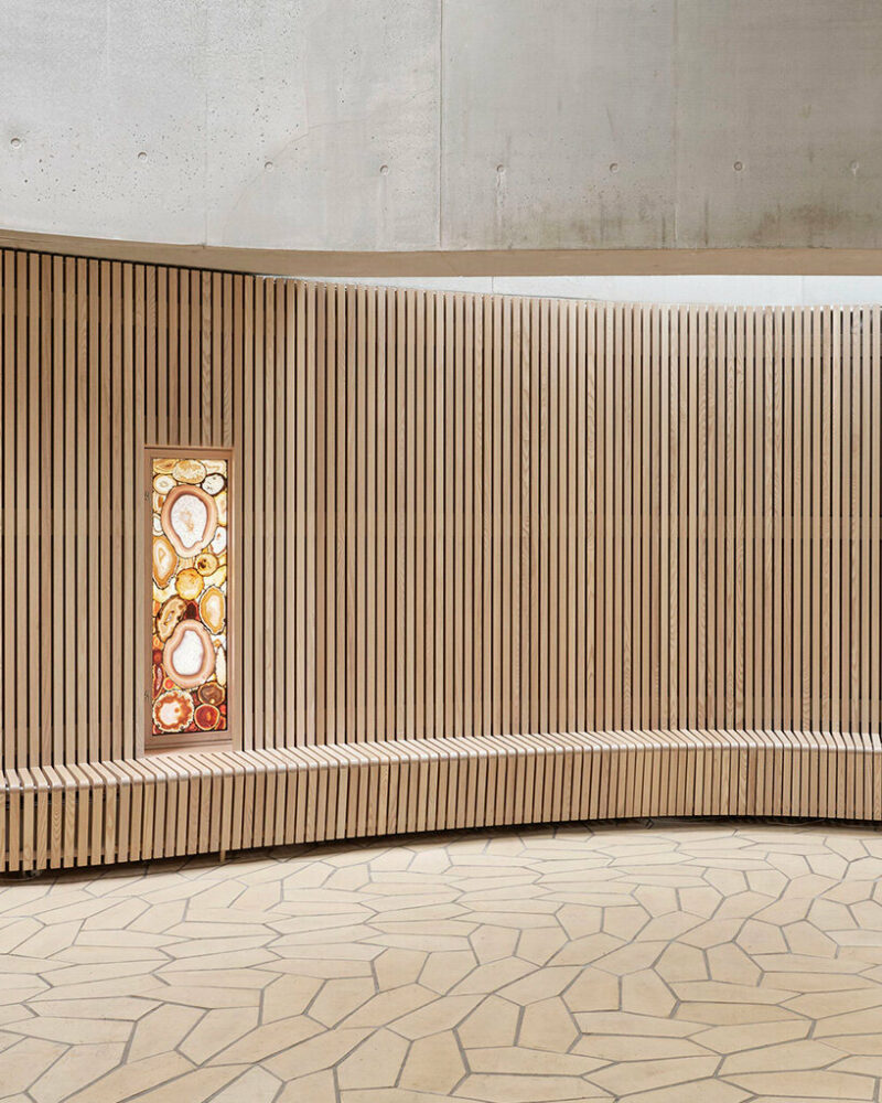 fluid concrete shell wraps timber interiors of danish trekroner church