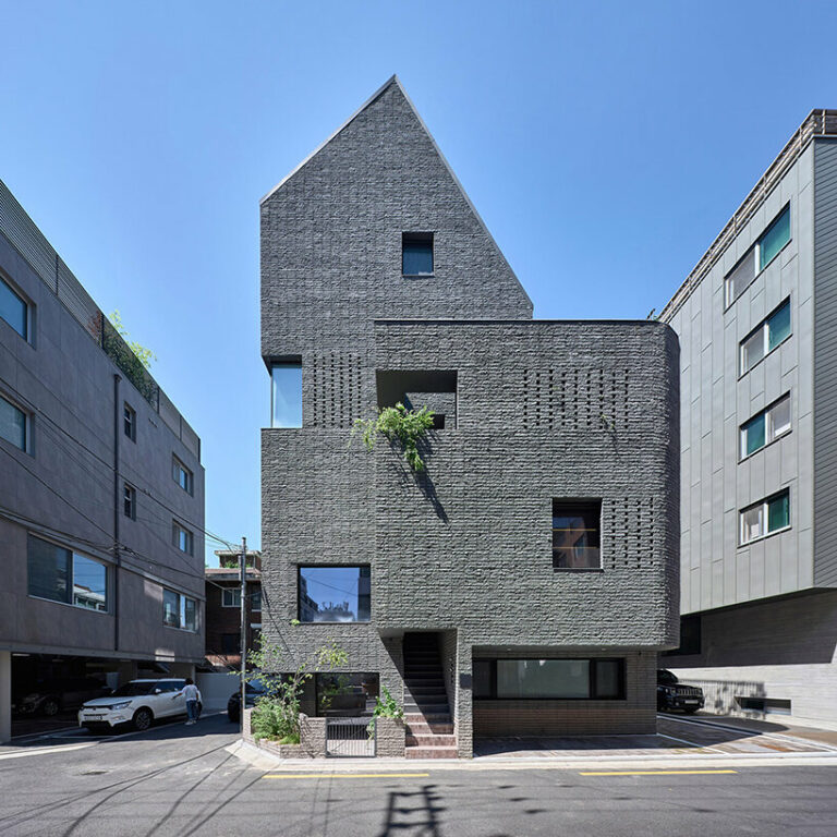 a round architects sculpts seoul office building with rusticated stone