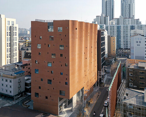 this undulating brick façade imitates the movement of draped fabric