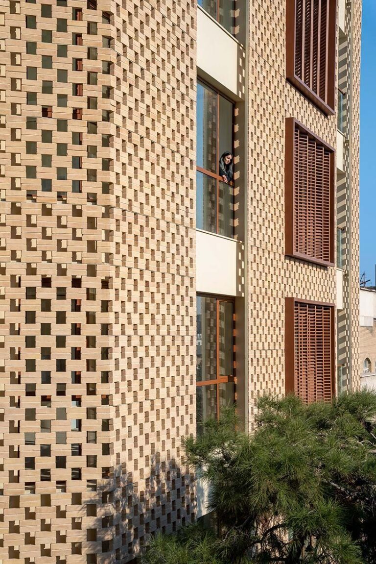 brick-layered facade shields zendegi building from harsh sunlight in tehran