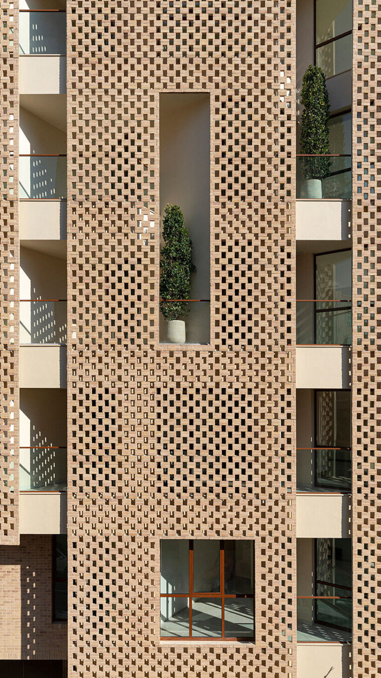 brick-layered facade shields zendegi building from harsh sunlight in tehran