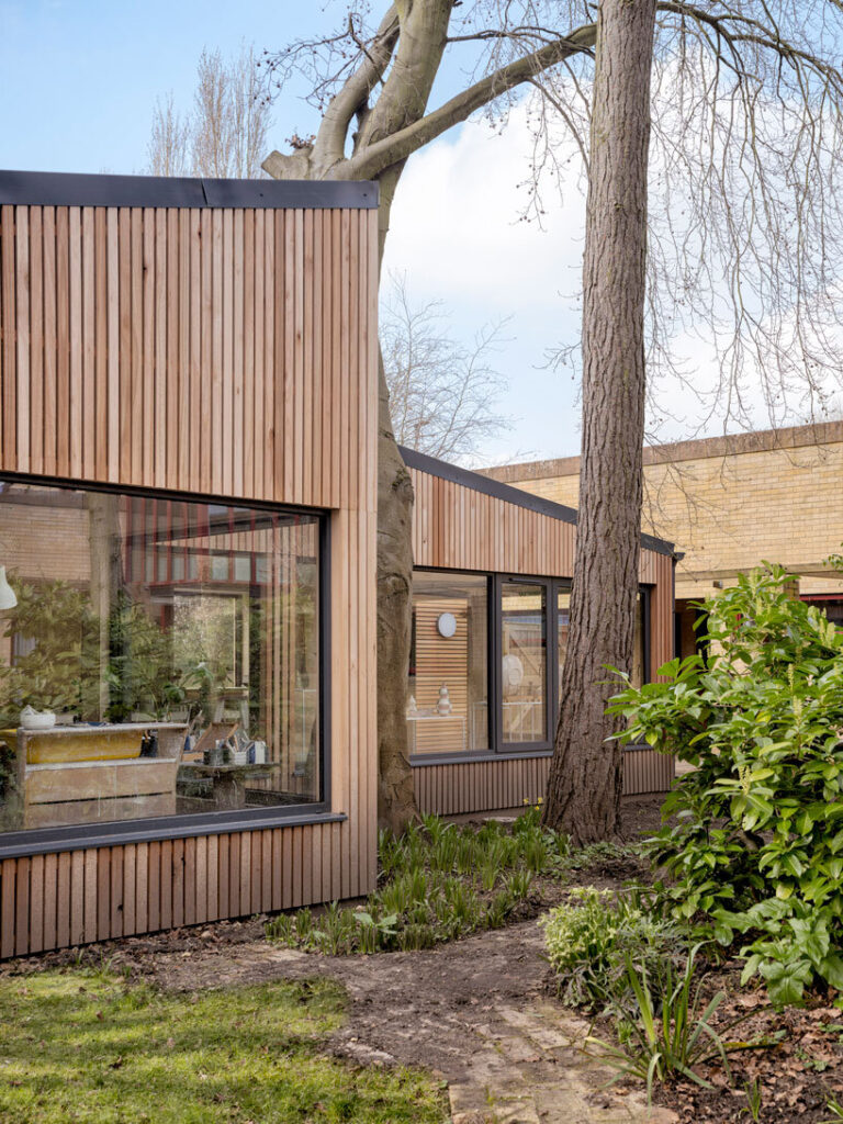 ceramic artist's wood-clad studio extends 80s-built house in the UK