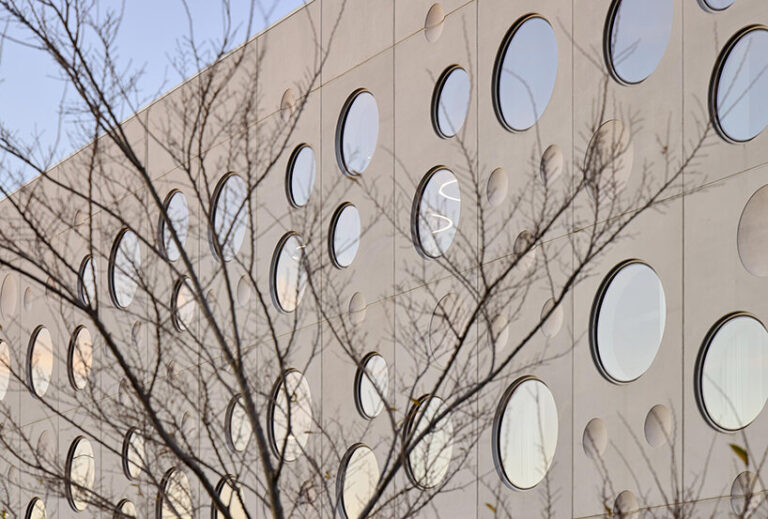 playful, circular windows punctuate buchan's library expressive facade ...