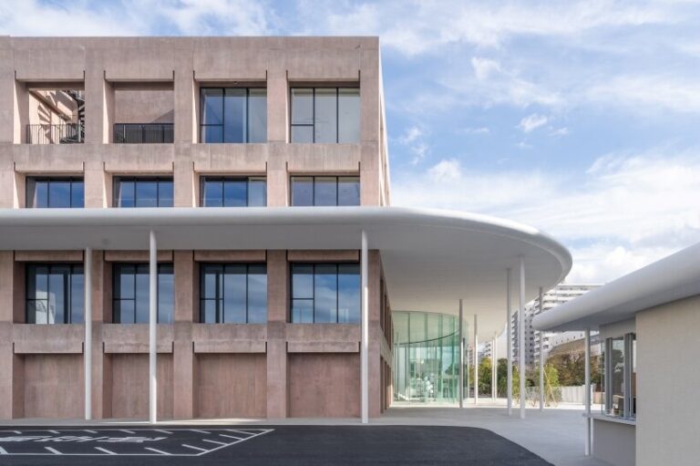 colored concrete buildings emerge from cloud-like floating roof at ...
