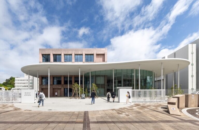 colored concrete buildings emerge from cloud-like floating roof at ...