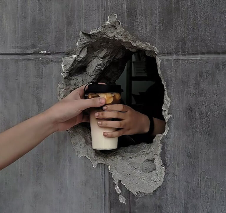 filipino café serves beverages through a hole in a concrete wall