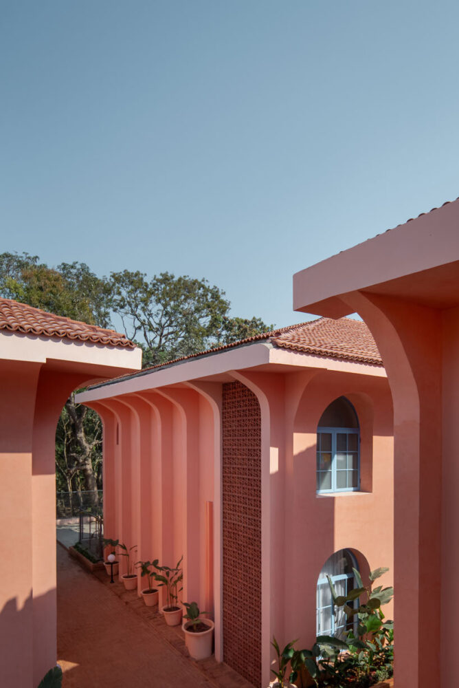 six u-shaped villas in north goa shape up bold pink arches around pool ...