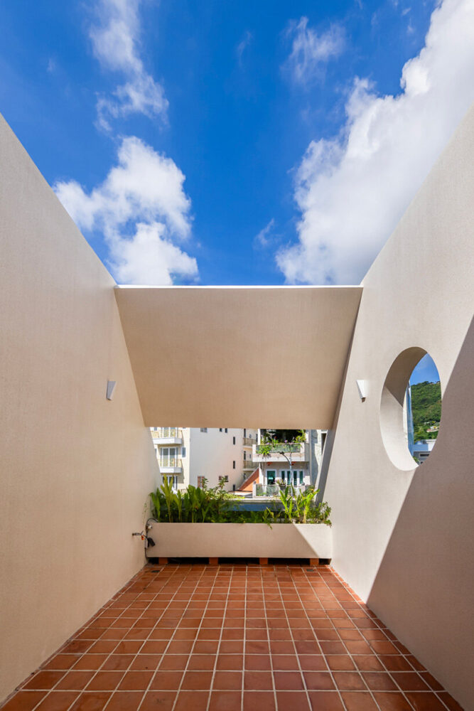 cutouts in slanted concrete roof illuminate vietnamese residence by DMA ...