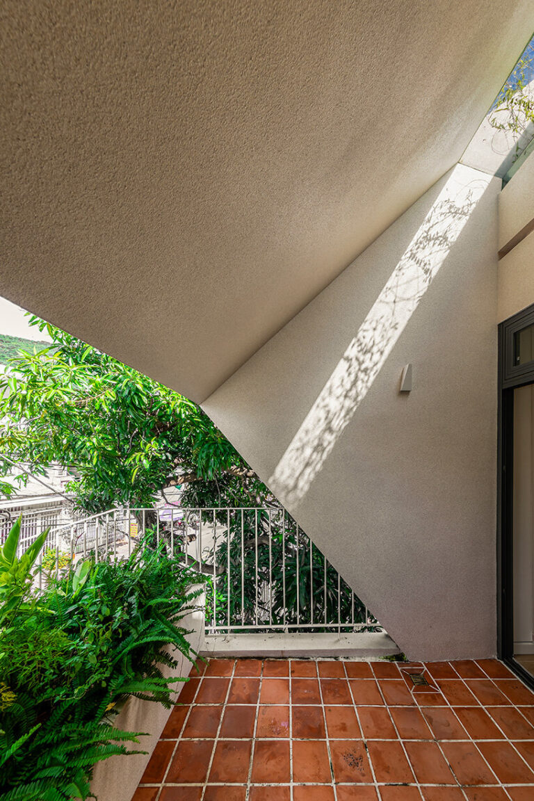 cutouts in slanted concrete roof illuminate vietnamese residence by DMA ...
