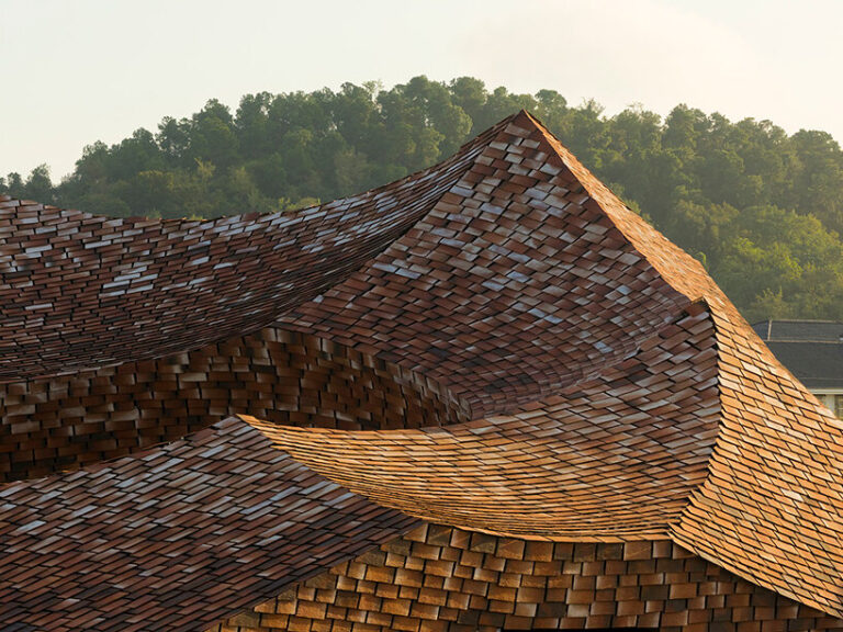 kengo kuma wraps undulating clay museum in ceramic panels