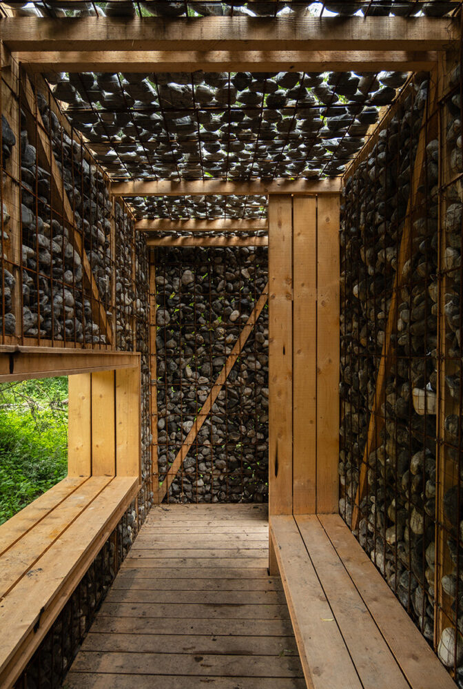 gabion walls frame tephra's stone shelter along dry riverbed in french ...