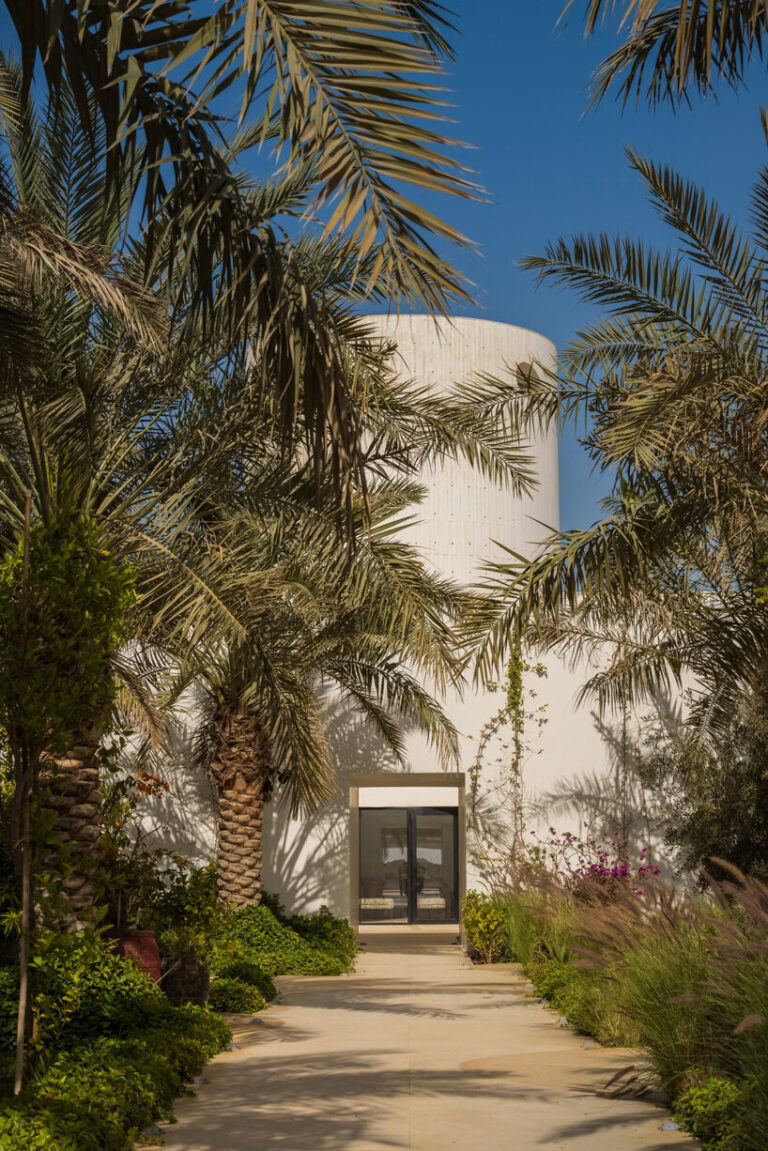 lighthouse-like tower rises amid white walls of TAEP/AAP's residence in ...