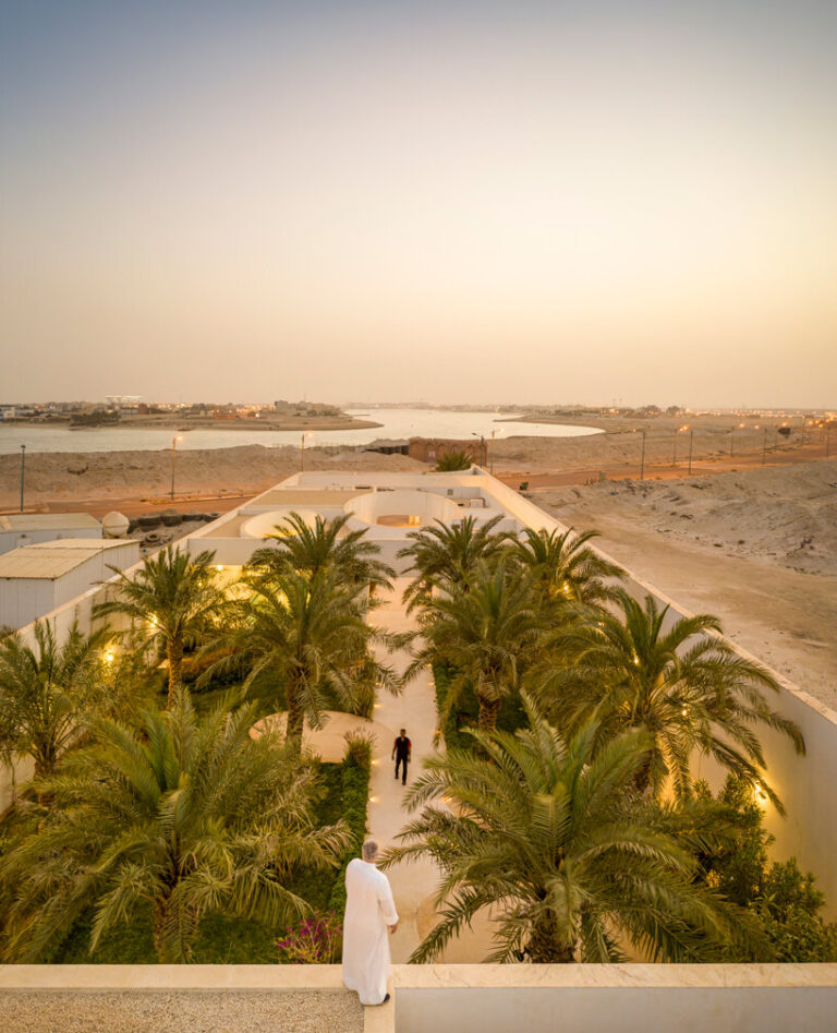 lighthouse-like tower rises amid white walls of TAEP/AAP's residence in ...