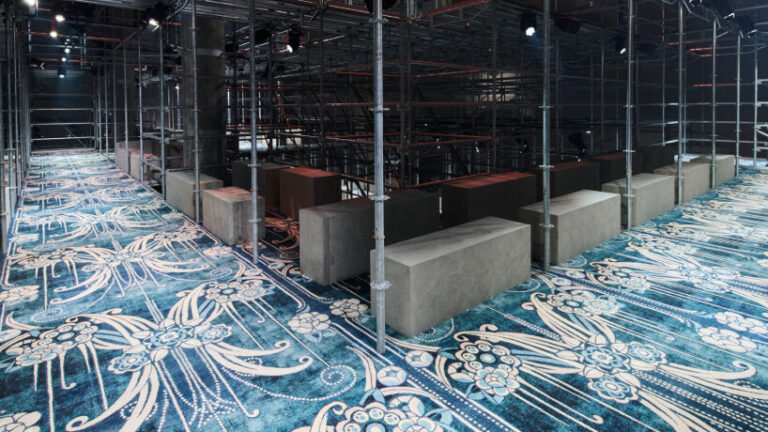 AMO surrounds prada FW25 set design with scaffolding structures