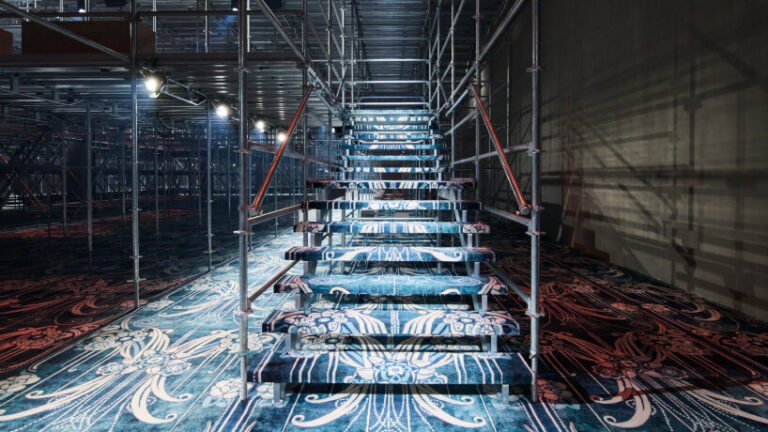 AMO surrounds prada FW25 set design with scaffolding structures