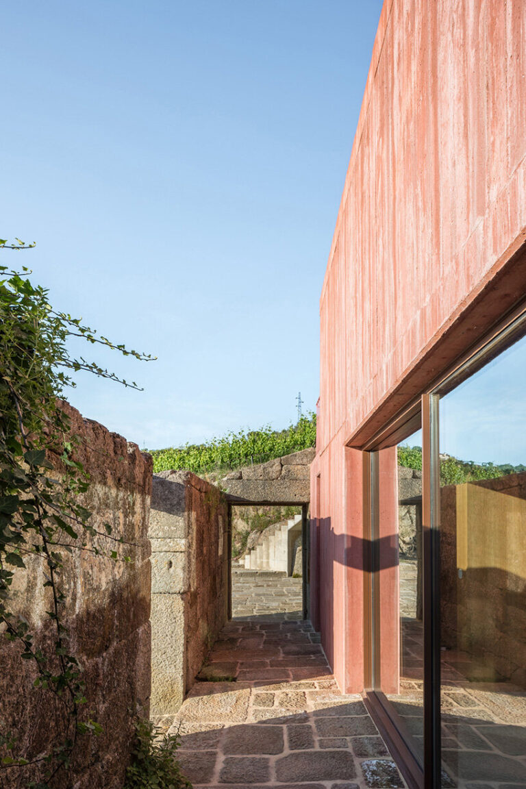 ancient wall envelops pink house by stefano riva in portugal