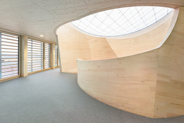 spiraling timber atrium by ICD connects floors at blumer lehmann HQ in ...