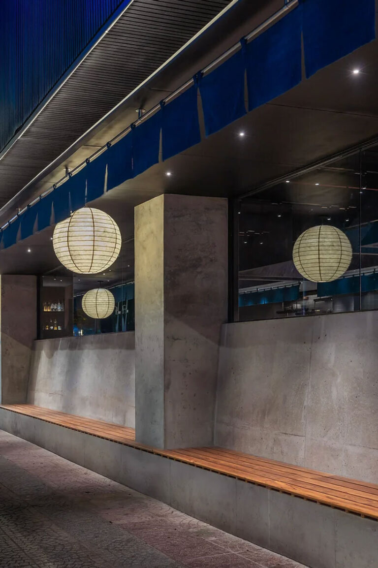indigo fabric partitions float above sculpted concrete counters in ...