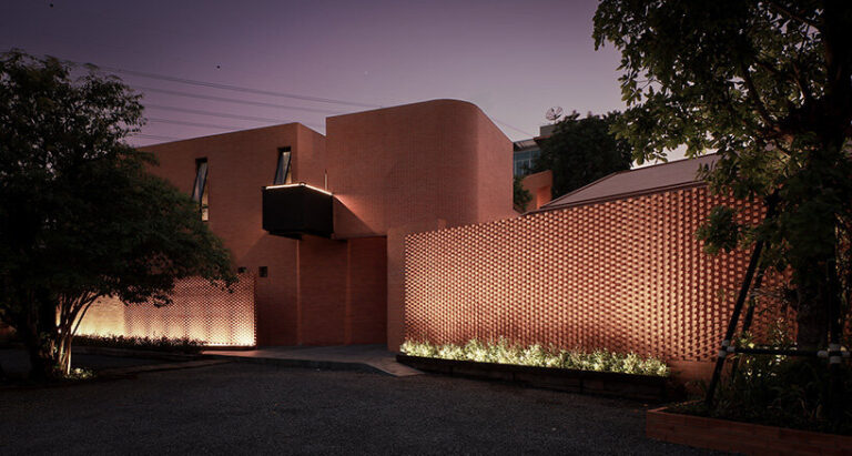 brick wall envelops volume matrix studio's building in bangkok