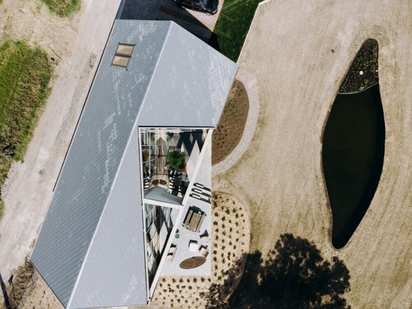 OYO architects carves triangular incision into farmhouse in belgium