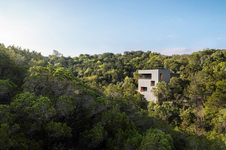 alterstudio's falcon ledge residence climbs steep ravine in austin