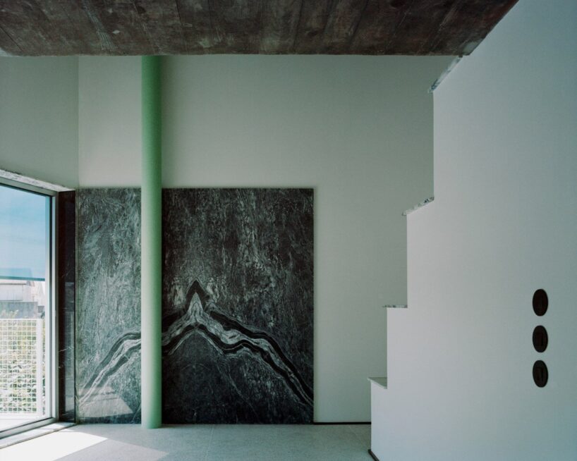 fala atelier inverts the sloped roof for sculptural home in portugal